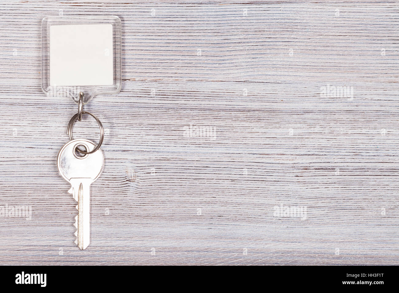 door key with white blank key chain on wooden surface Stock Photo - Alamy