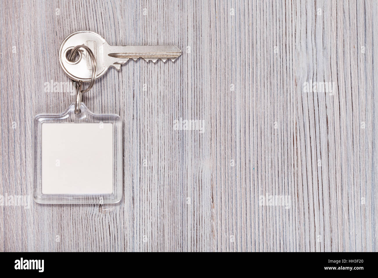 door key with white blank key chain on wooden background Stock Photo ...