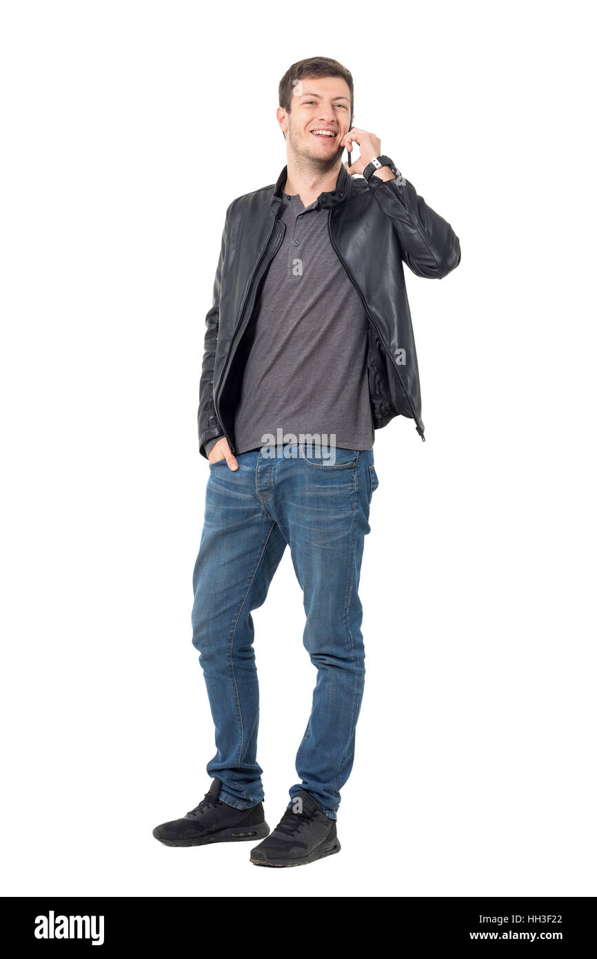 Young casual man talking on the mobile phone laughing and looking at ...