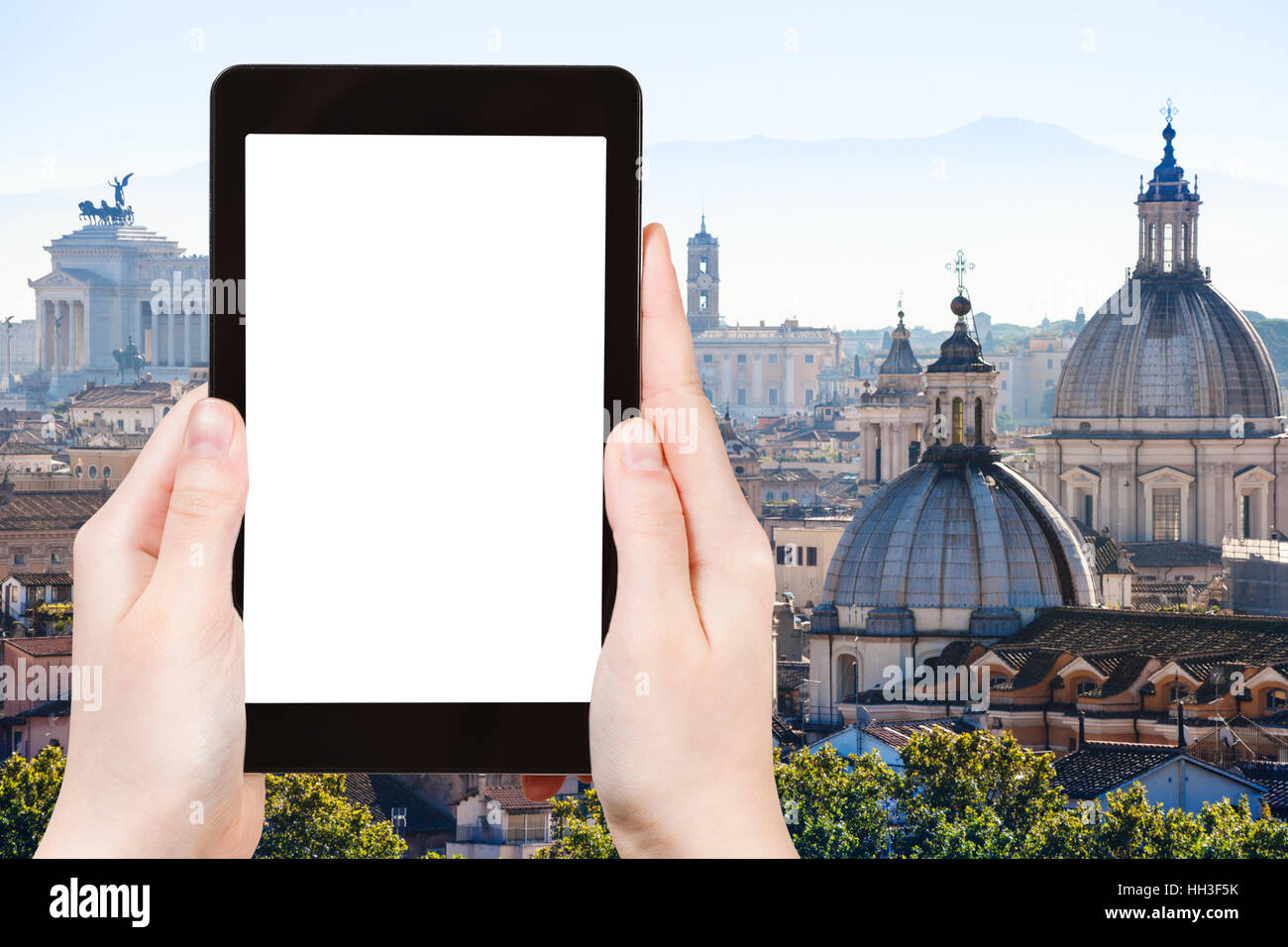 travel concept - tourist photographs skyline of Rome town on tablet ...