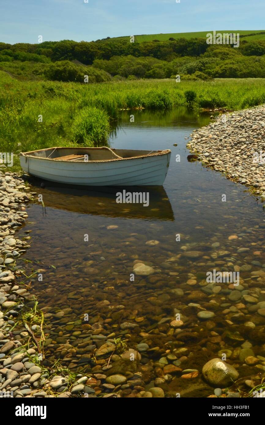 An abandoned rowing boat on a stream near the Pembrokeshire Coastal ...
