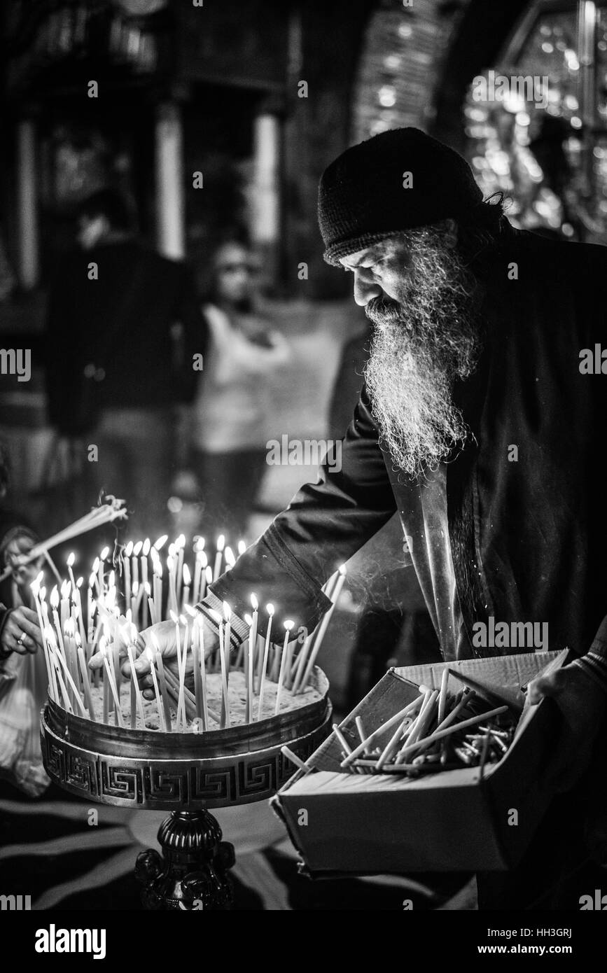 A Greek Orthodox cleric in the Crucifixion altar in the Church of Holy ...