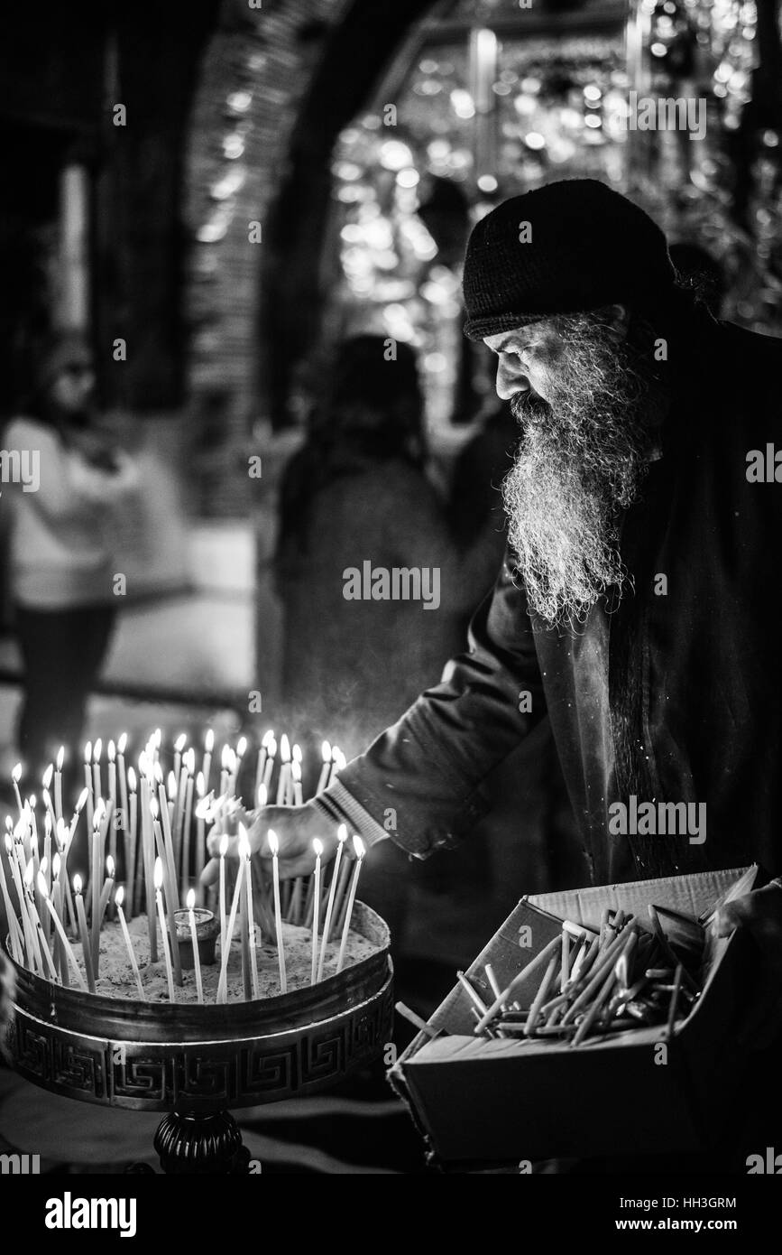 A Greek Orthodox cleric in the Crucifixion altar in the Church of Holy ...