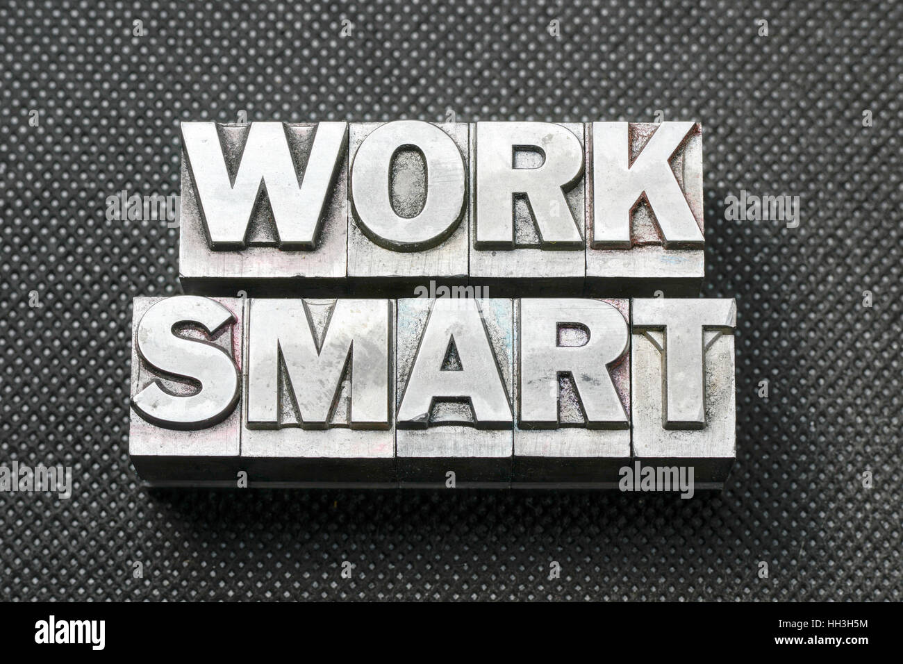 work smart phrase made from metallic letterpress blocks on black ...
