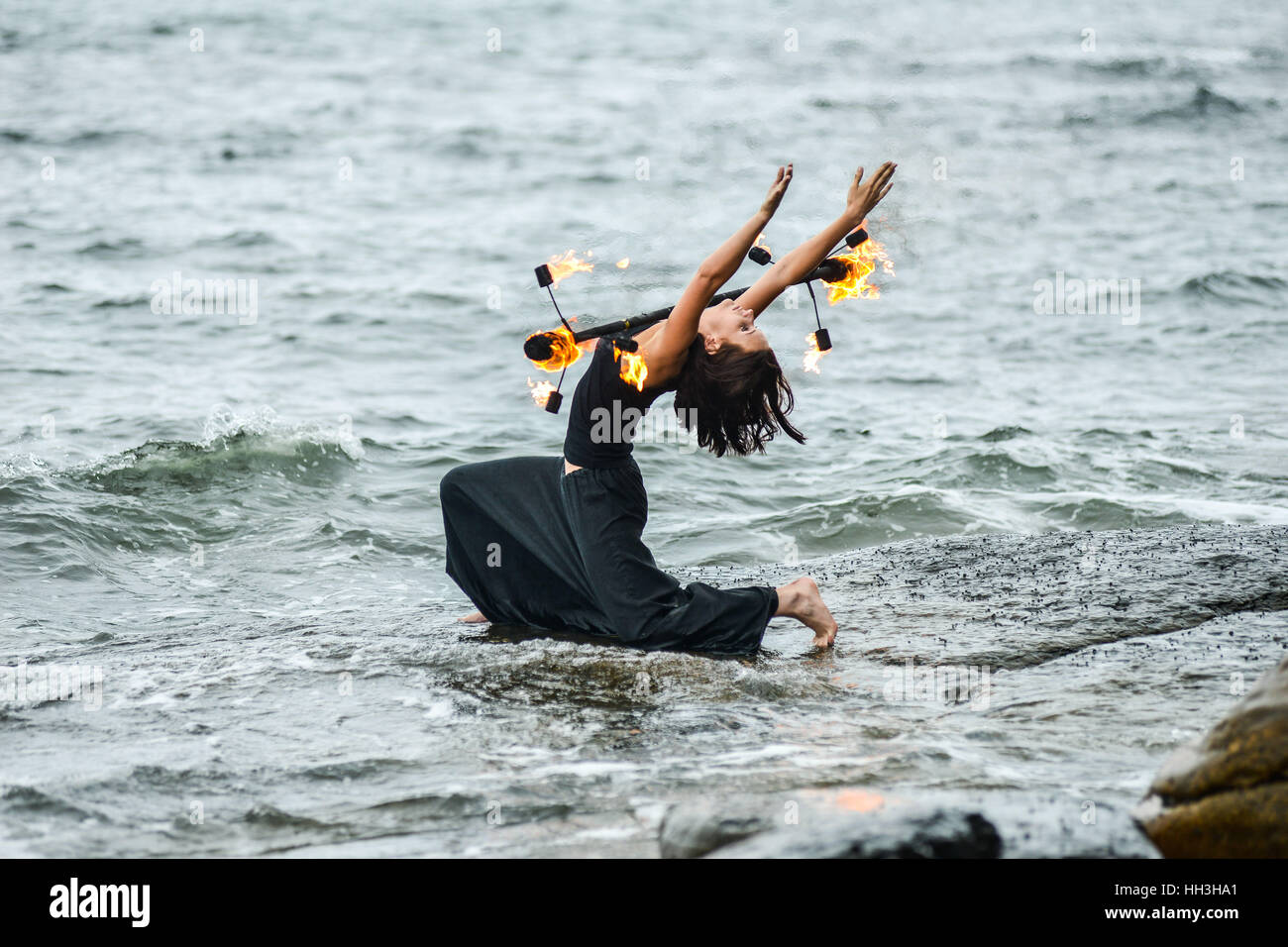 play with fire show on the shore of the sea Stock Photo - Alamy
