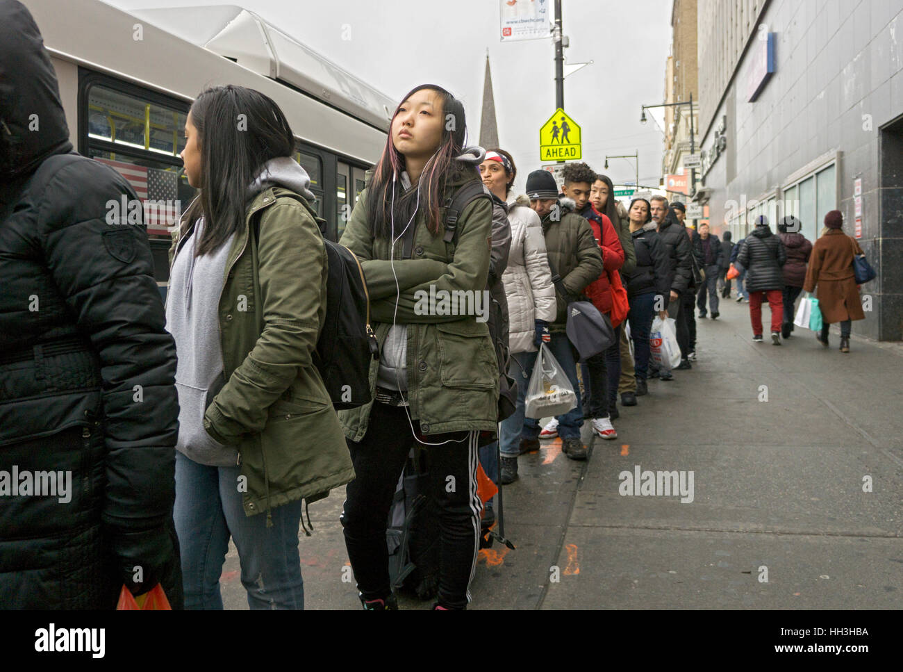 A long line on a bus stop on Main Street in Chinatown, downtown ...