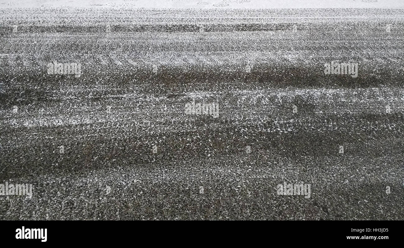 Snowy road in winter with tire tracks Stock Photo - Alamy