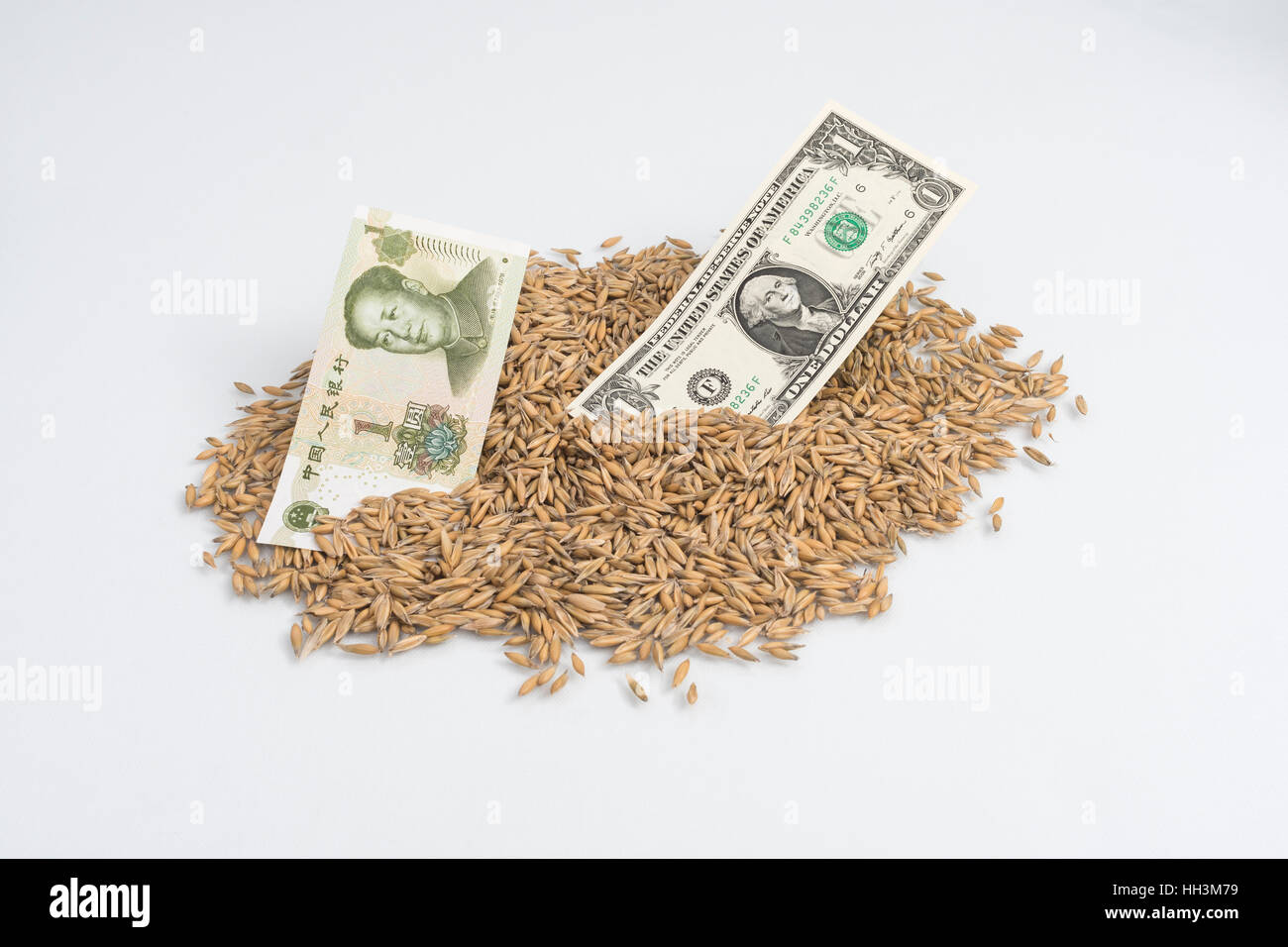 Pile of wheat grain with Chinese 1 Yuan and US Dollar banknotes / bills ...