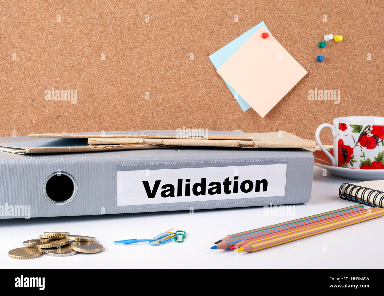 Validation. Folder on office desk. Money, Coffee Mug and colored ...