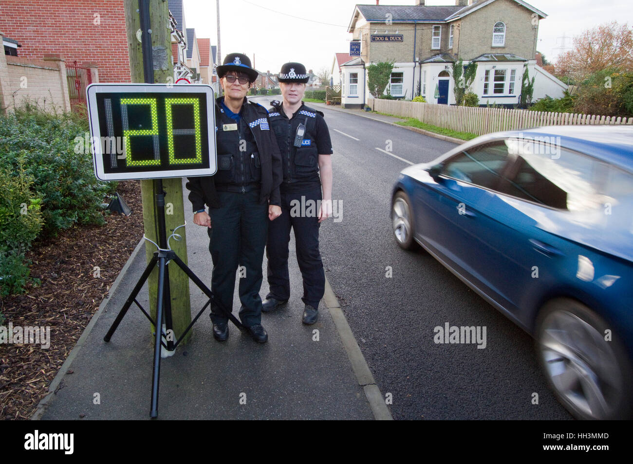 Two women police officers, a speed indicator and a passing car Stock ...