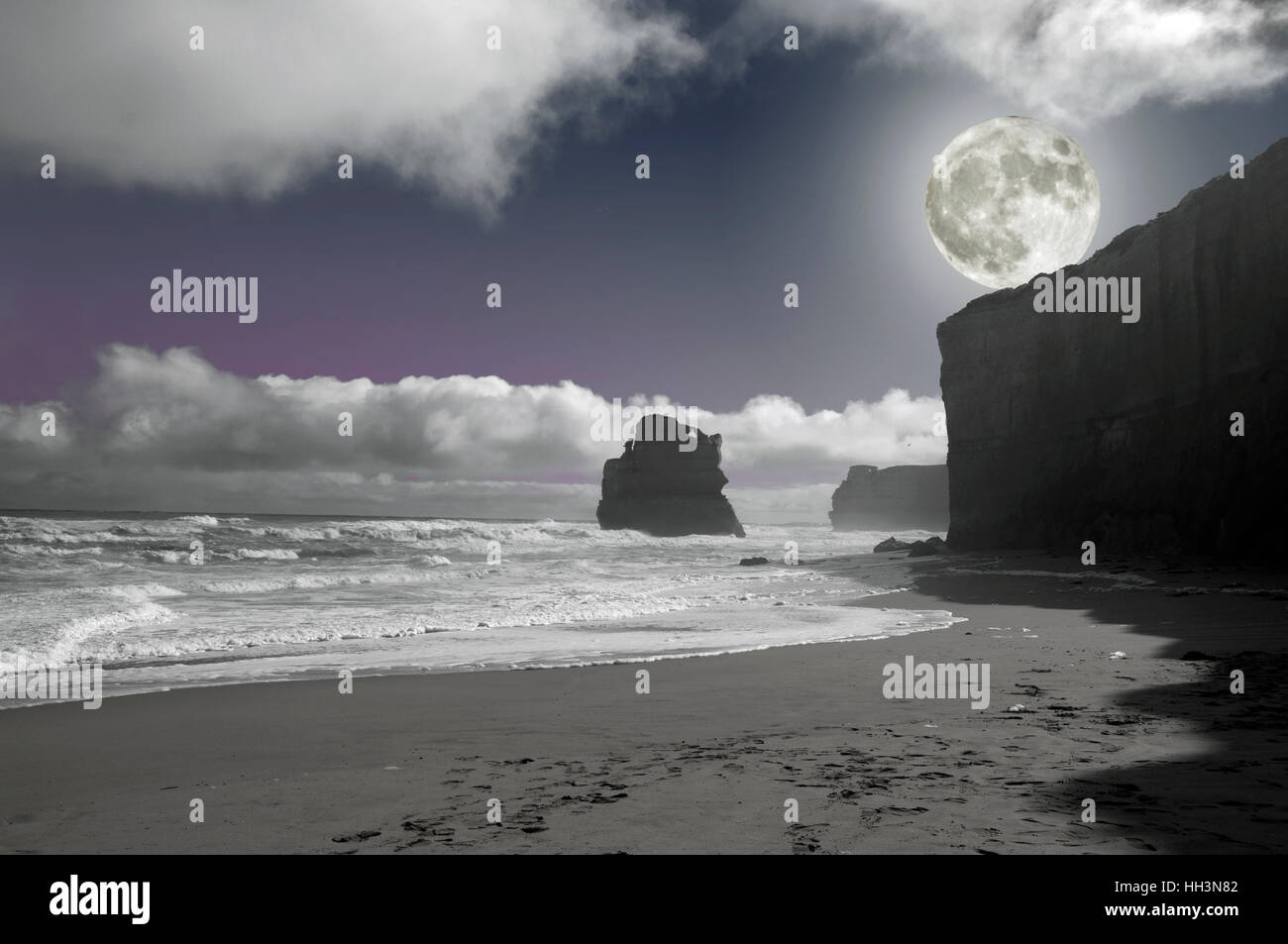 Rocky coast of the ocean at night in full moon light Stock Photo - Alamy