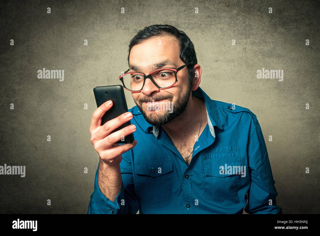 geek with the beard and phone Stock Photo - Alamy