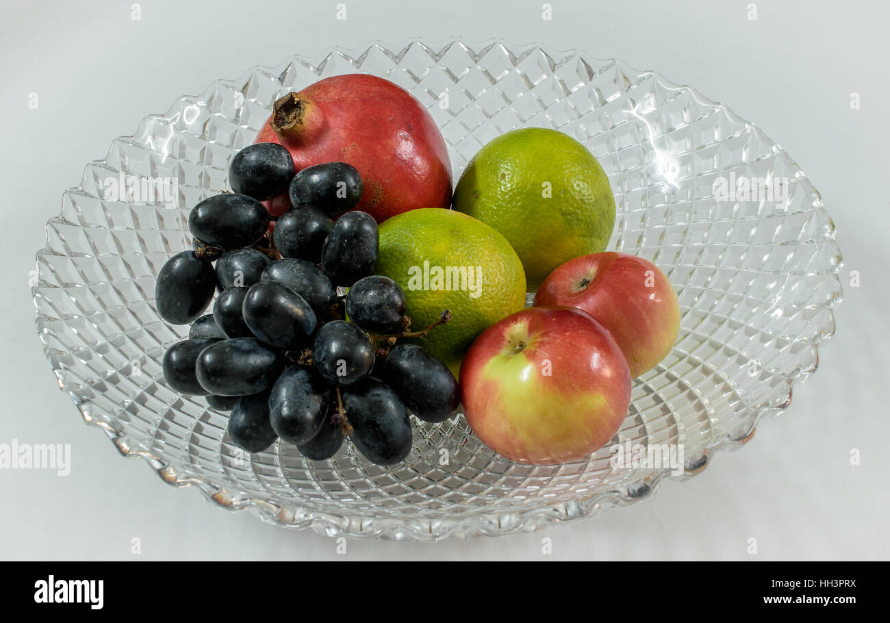 Mixed fruits within a glass bowl with white background Stock Photo - Alamy