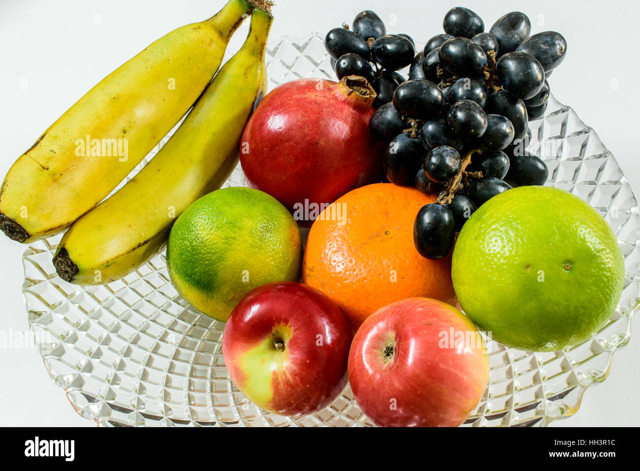 Mixed fruits within a glass bowl with white background Stock Photo - Alamy
