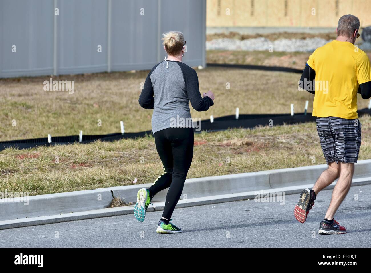 A married couple going for a run through the neighborhood Stock Photo ...