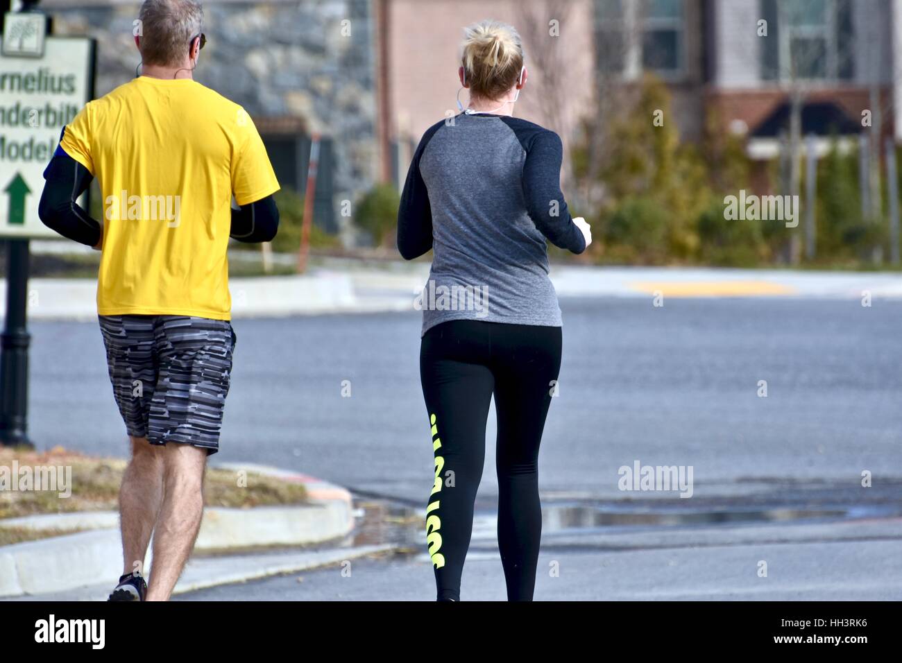 A married couple going for a run through the neighborhood Stock Photo ...