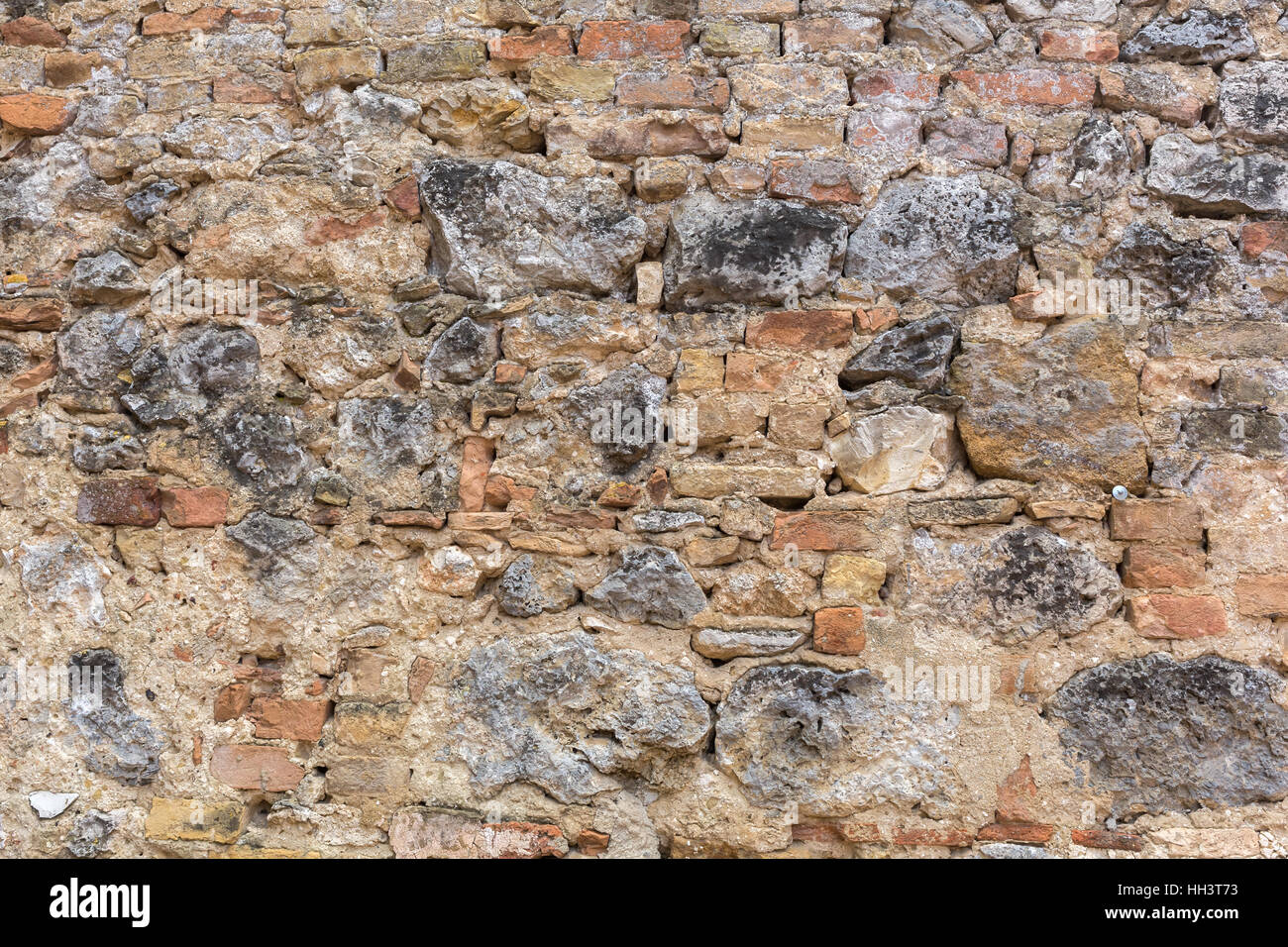 background texture from a stone wall of an old building in Tuscany ...