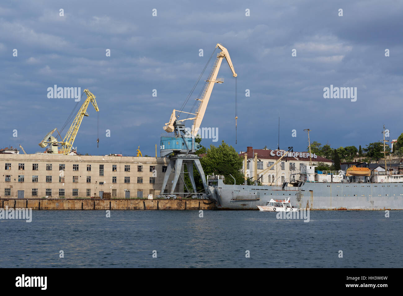Lifting cargo cranes at the shipyard in Bay of Black Sea Stock Photo ...