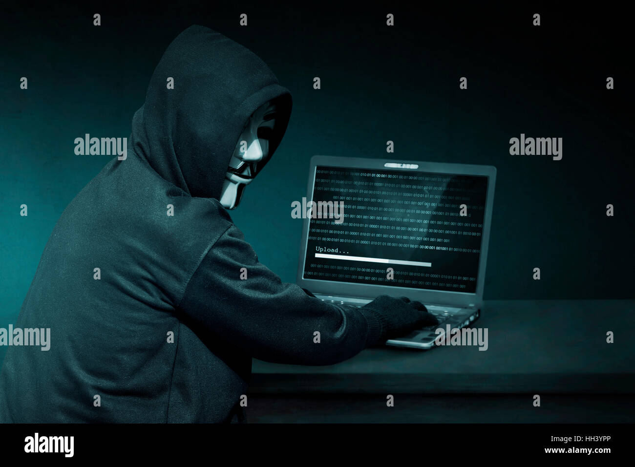 Hacker anonymous mask using laptop hi-res stock photography and images ...