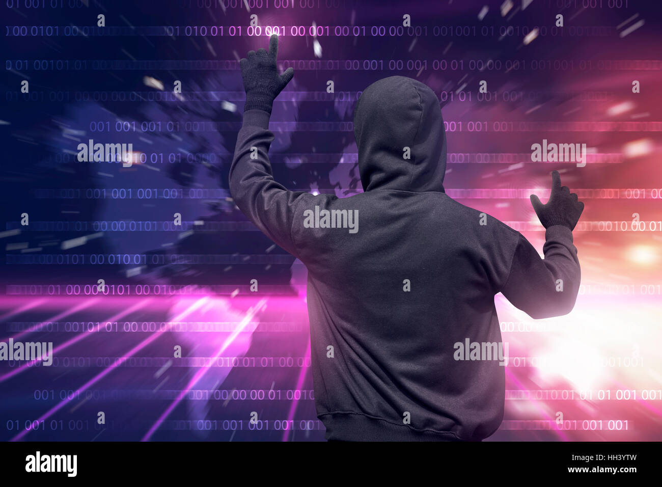 Rear view of hooded hacker using virtual screen to hacking internet ...
