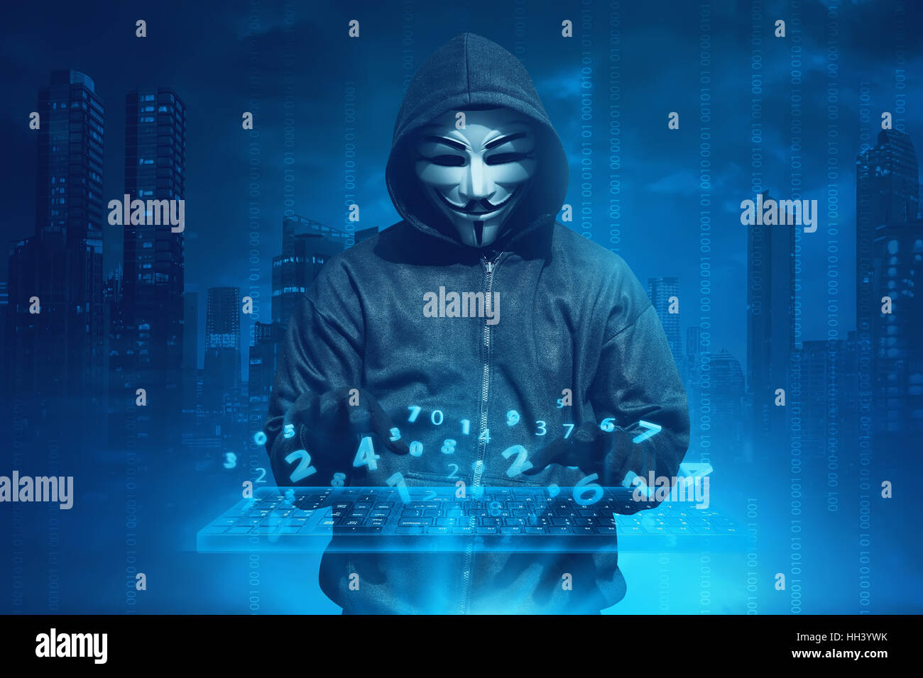Hooded man with anonymous mask hacking system online security against concept background Stock ...