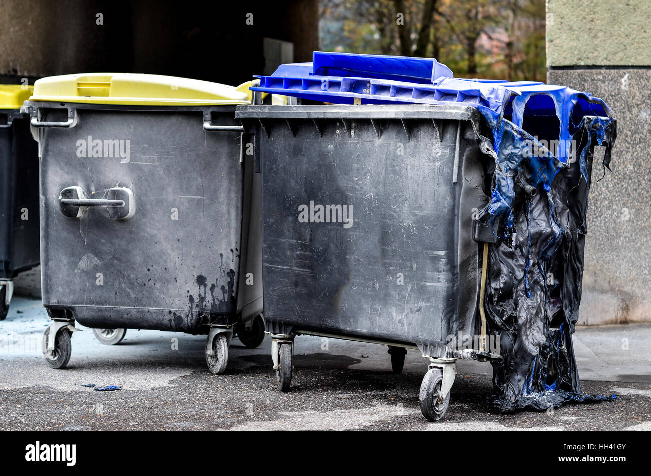 Burnt and melted trash can from fire. Burned trash in waste container ...