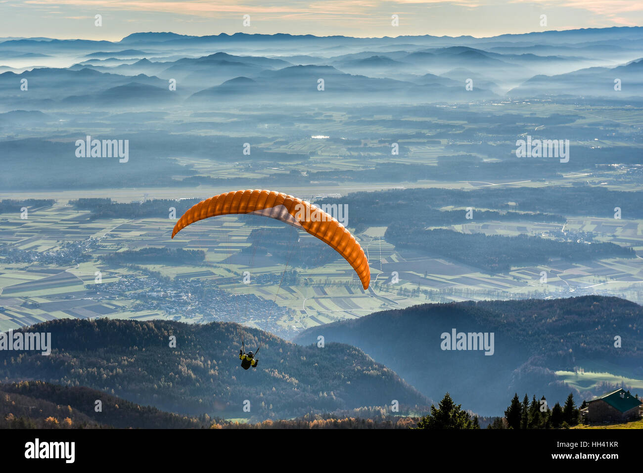Paraglider is flying in the valley. Paragliding from the mountain with ...