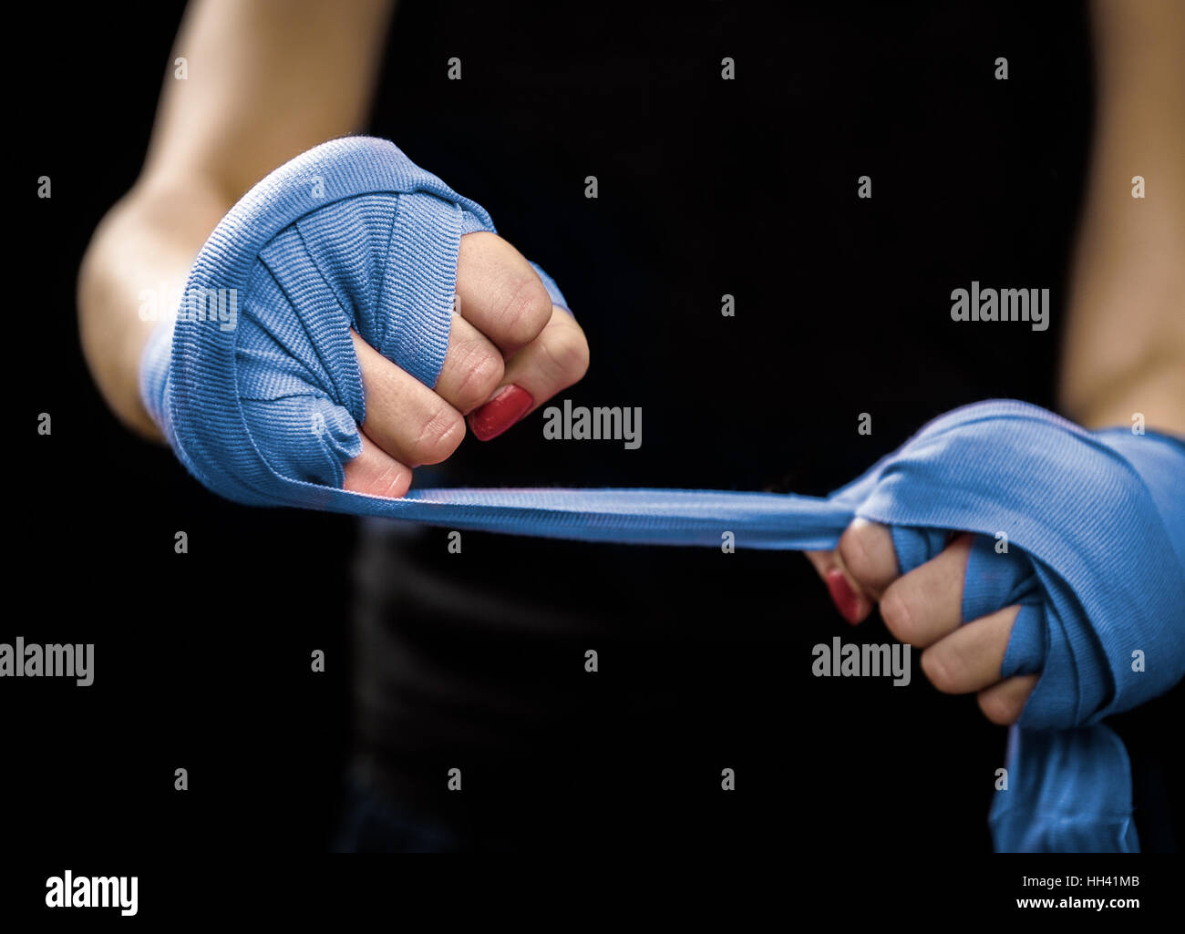 Woman is wrapping hands with blue boxing wraps. Self Defense for Women ...