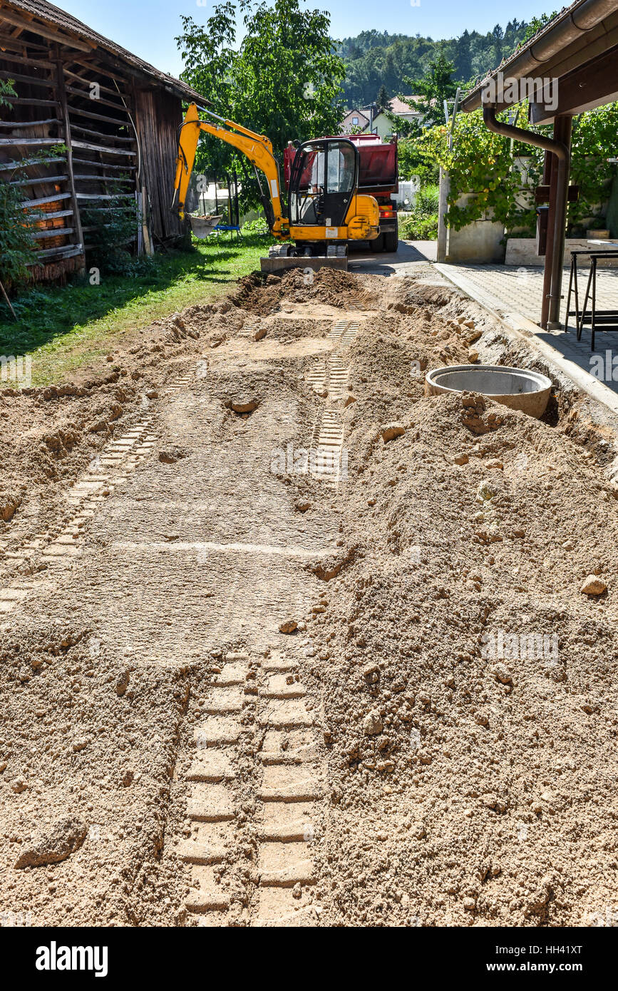 Making and constructing a new asphalt road with sewer pipes, truck and ...