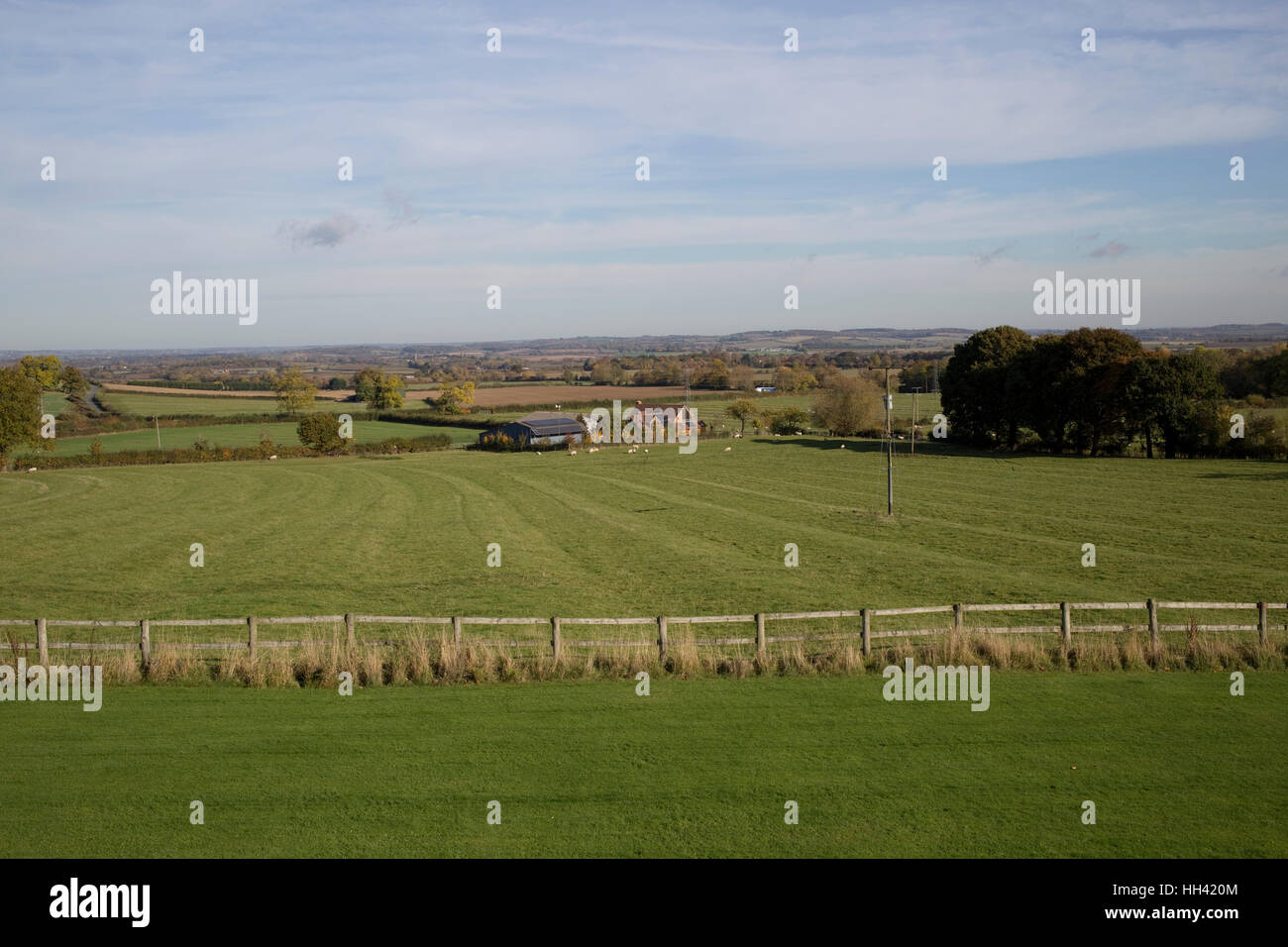 Cotswold landscape with ridge and furrow field and farm buildings ...