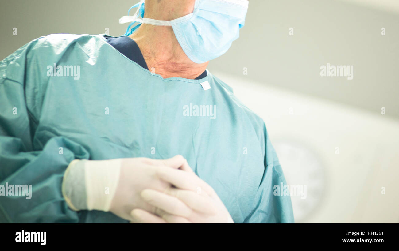 Surgeon in hospital surgery in sterile uniform "scrubs" and mask in ...
