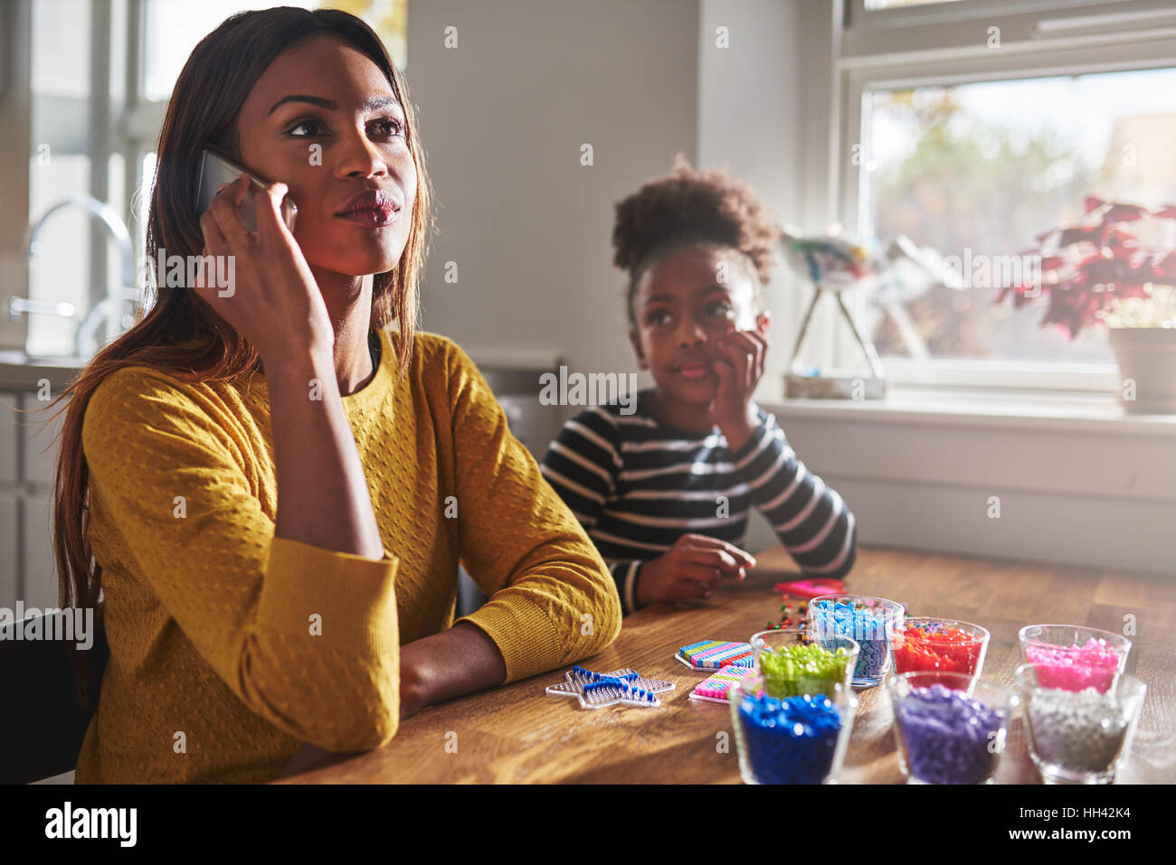 Mother talking on phone forgetting child that waits for mother to play ...