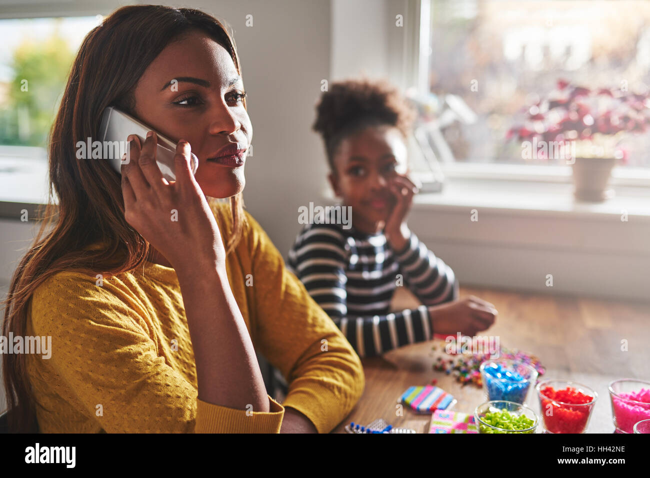 Mother talking on phone forgetting child that sits staring in ...