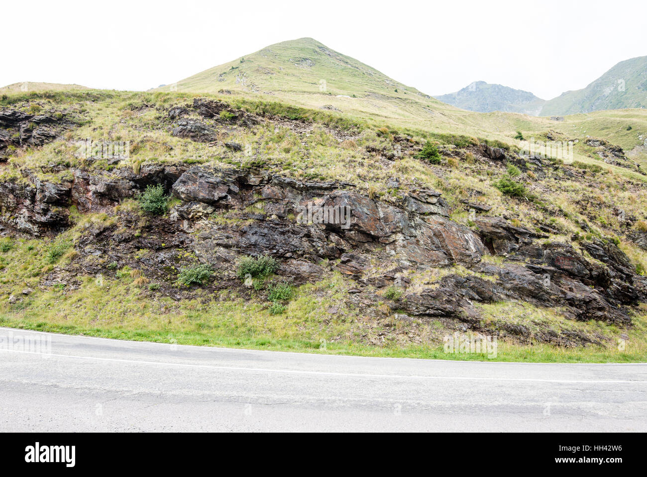Winding country Road with clouds above and dry tarmac Stock Photo - Alamy