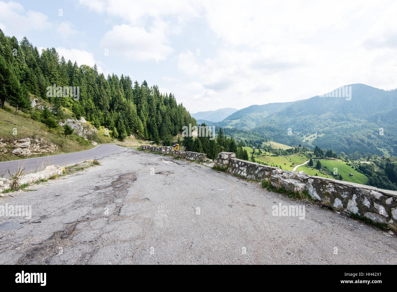 Winding country Road with clouds above and dry tarmac Stock Photo - Alamy