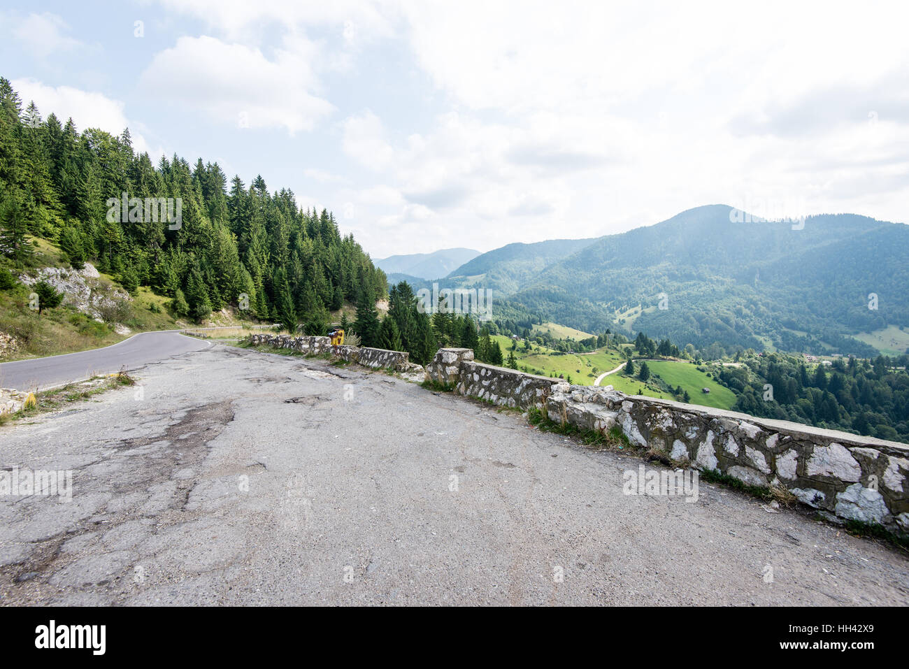 Winding country Road with clouds above and dry tarmac Stock Photo - Alamy