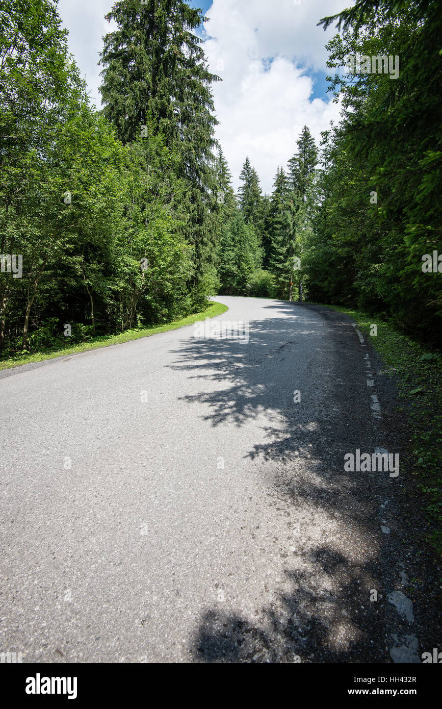 Winding country Road with clouds above and dry tarmac Stock Photo - Alamy