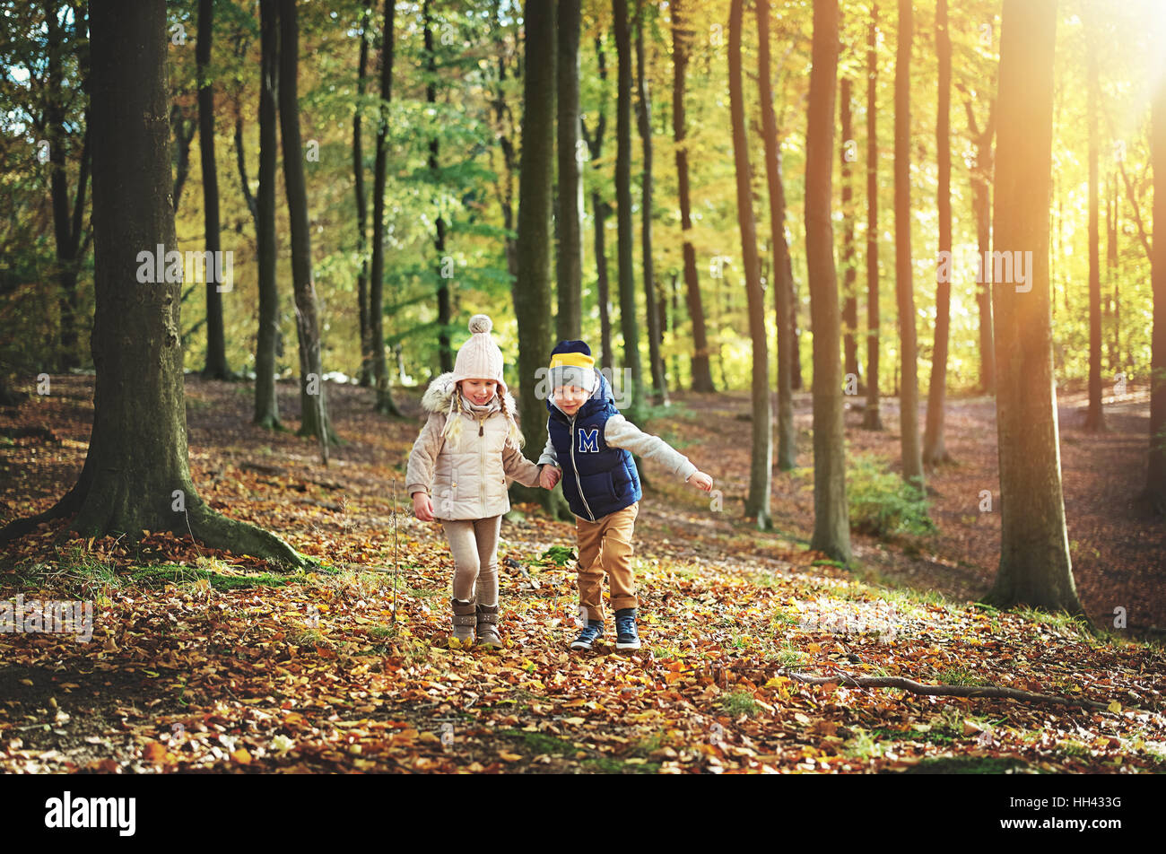 Two wandering in forest children. Horizontal outdoors shot Stock Photo ...