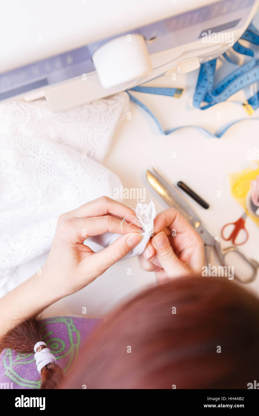 Girl with cloth in hand in studio with sewing machine Stock Photo - Alamy