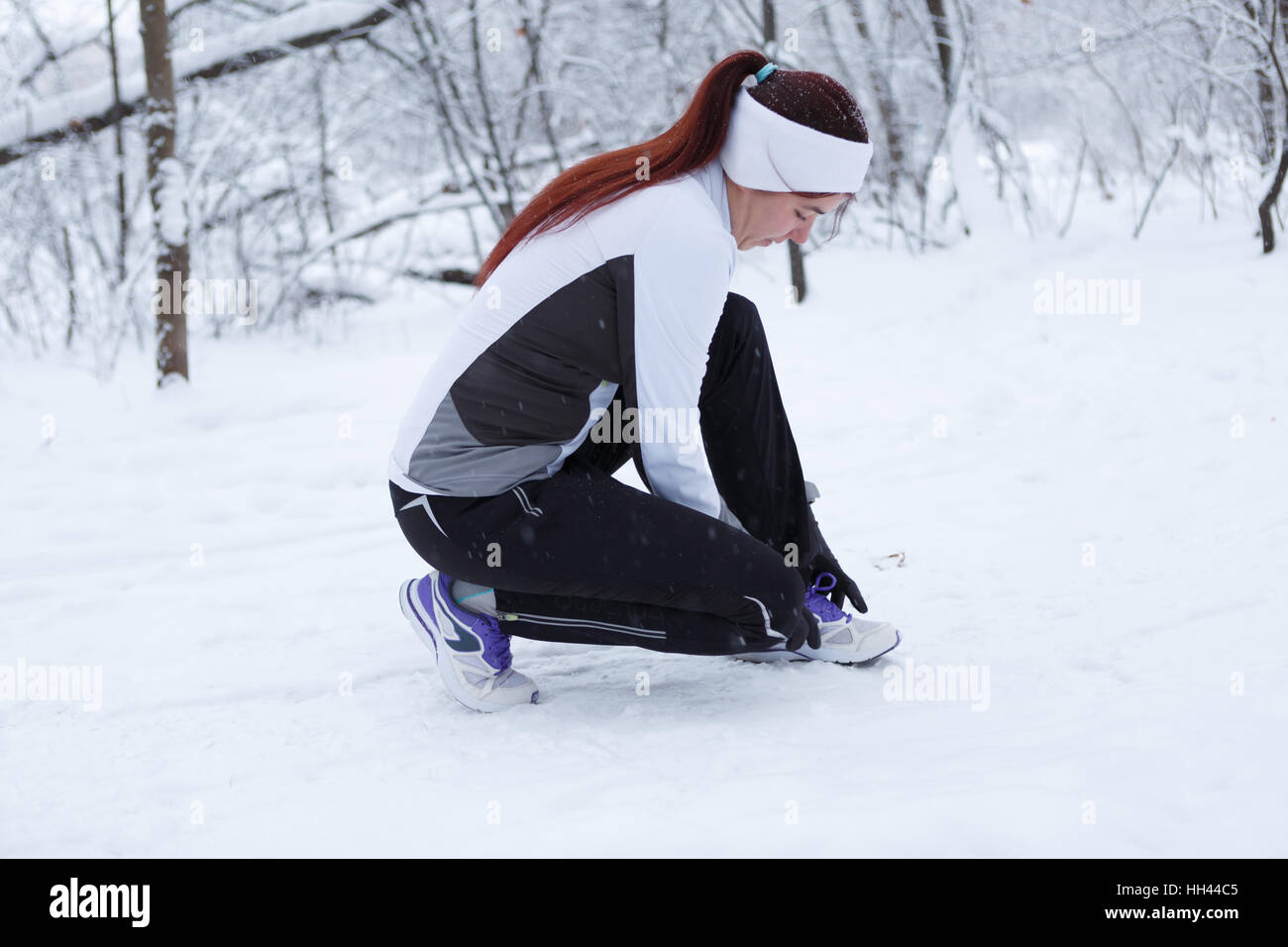 Sport girl in sports form in winter forest day Stock Photo - Alamy