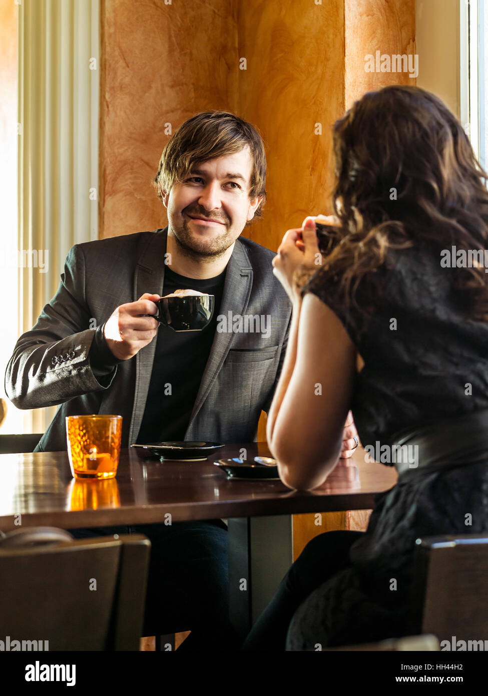 Photo of a young couple sitting in a restaurant on a romantic date ...