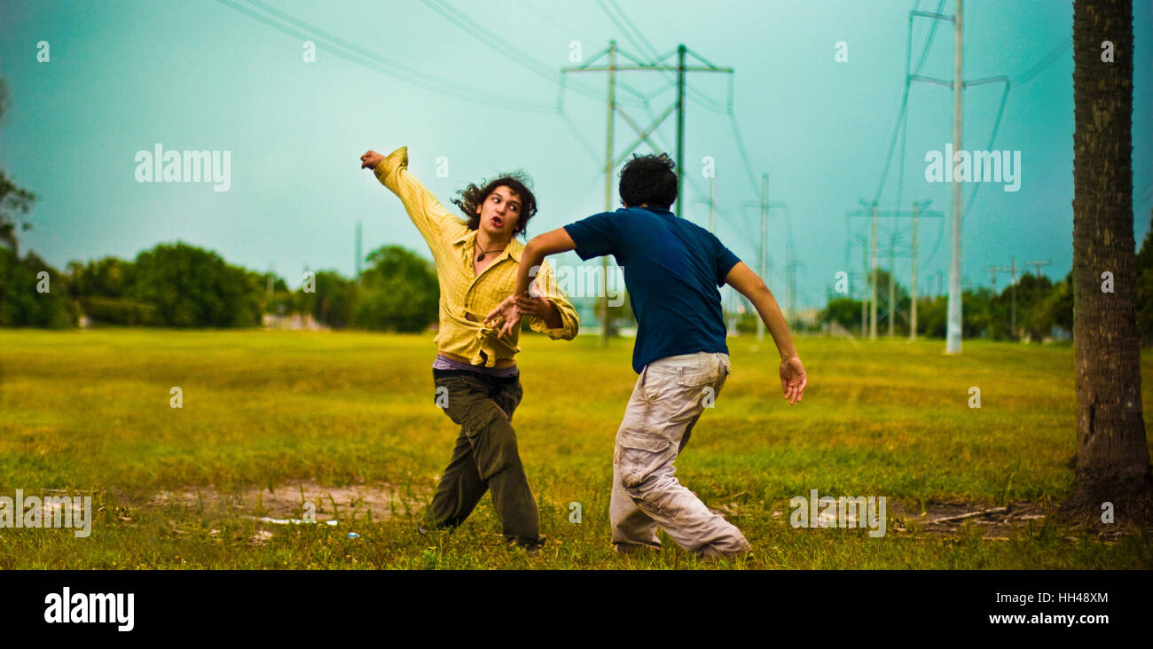 Two boys fighting on a green field Stock Photo - Alamy