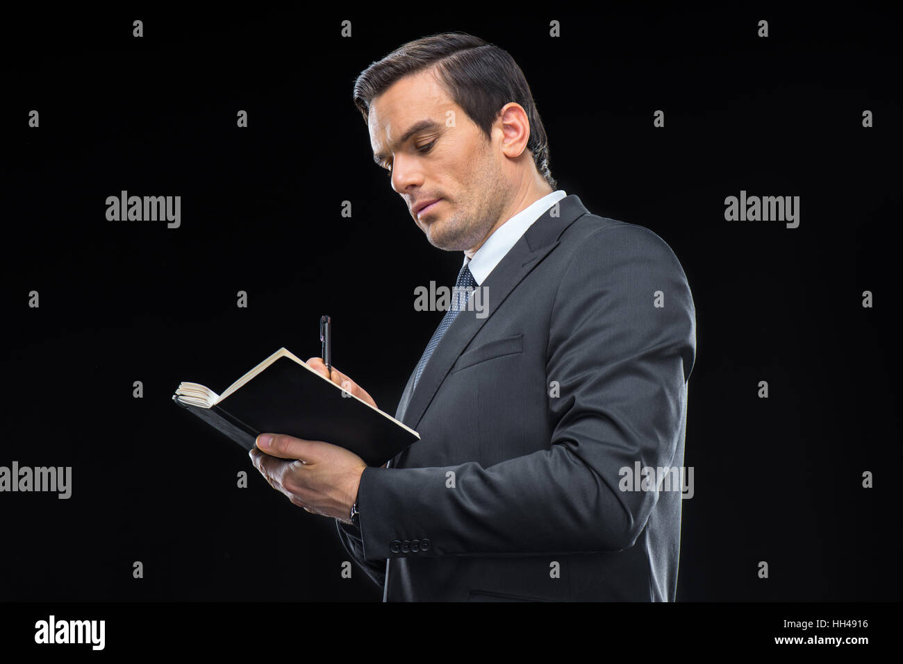 Handsome man writing on notebook hi-res stock photography and images ...