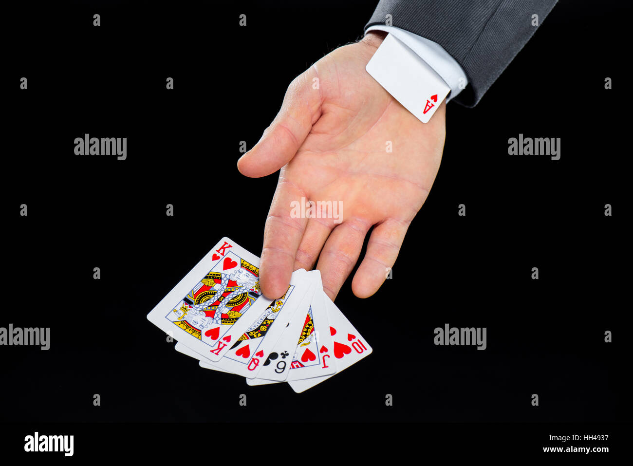 Partial view of man holding playing cards with hidden in sleeve ace of ...