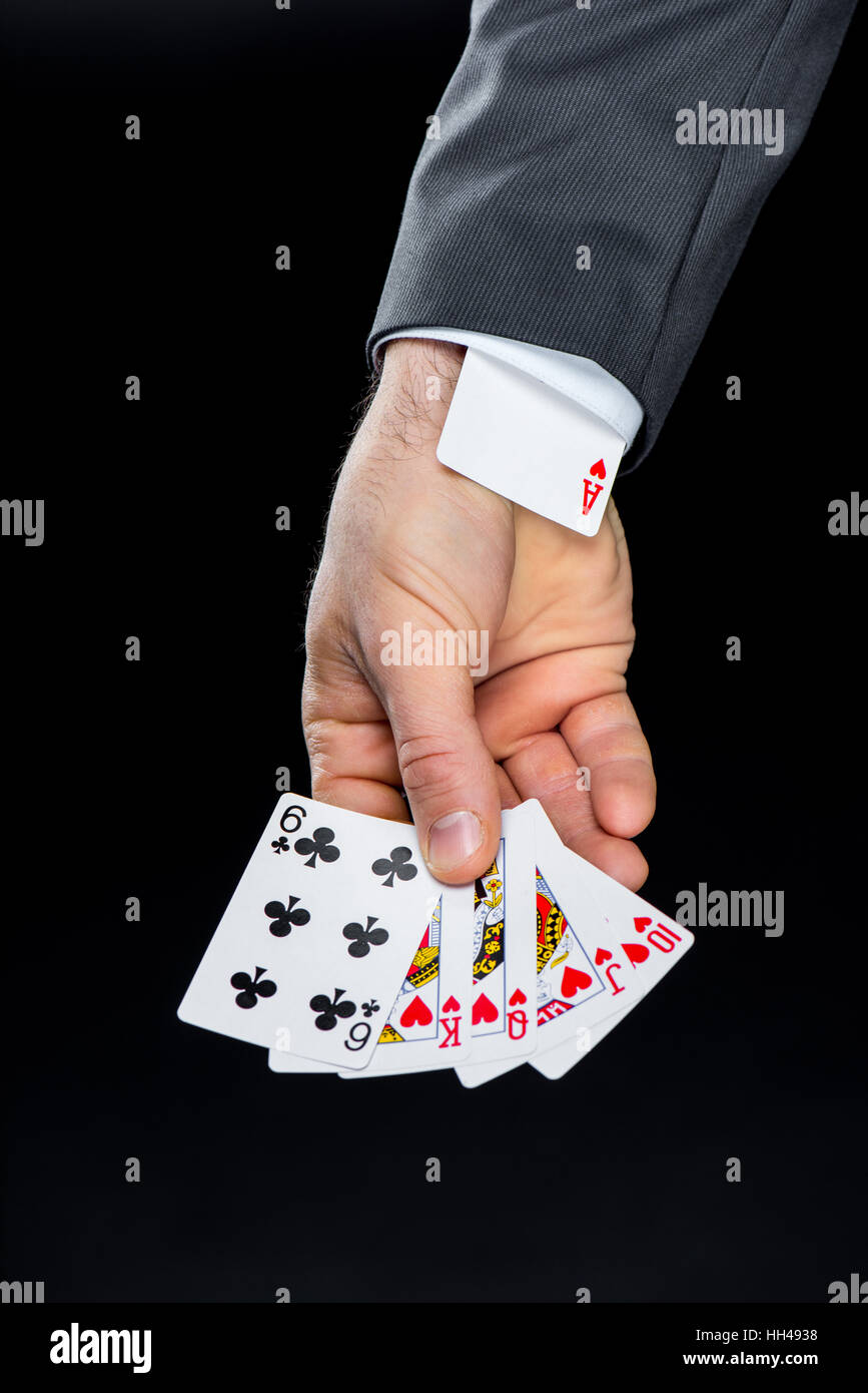 Partial view of man holding playing cards with hidden in sleeve ace of ...