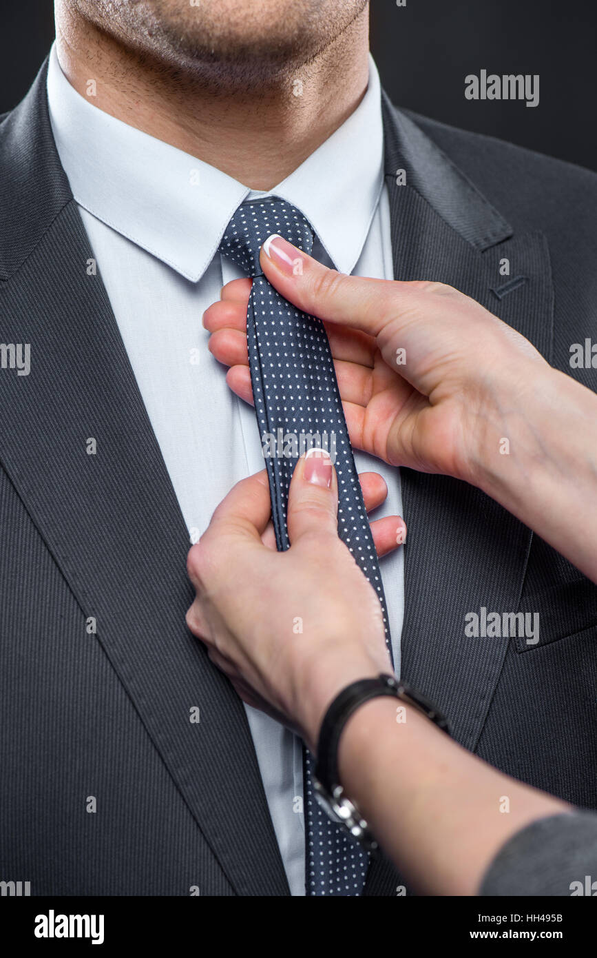 Close-up partial view of woman adjusting neck tie of man Stock Photo ...