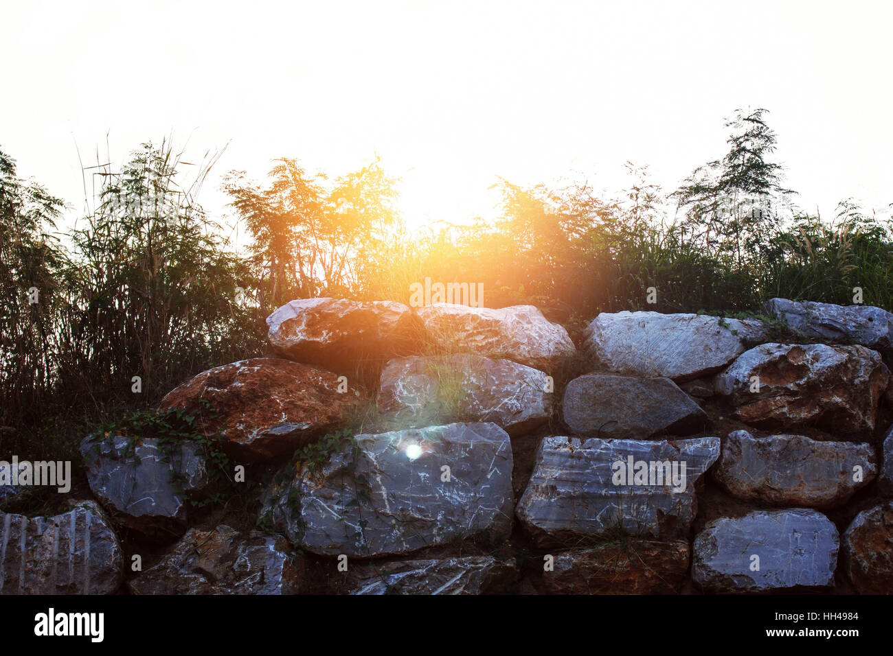 The sun shines down on a stone wall Stock Photo - Alamy