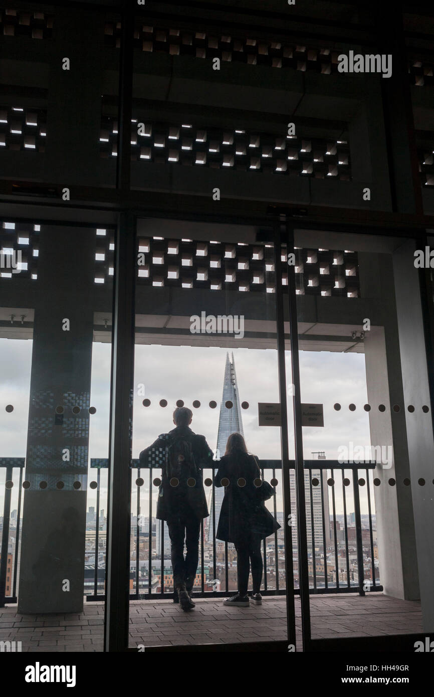 Two people look out over London on the viewing terrace at Tate Modern ...