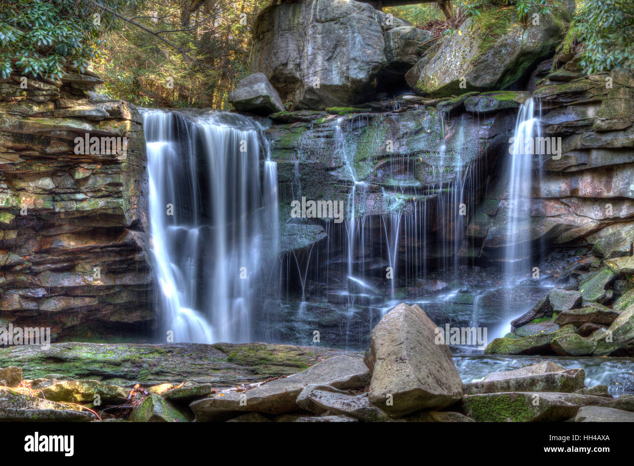 Water falling gracefully over a natural rock wall Stock Photo - Alamy