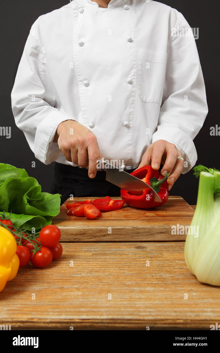Photo of a chef chopping vegetables on a wooden cutting board Stock ...